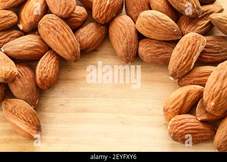 Almonds on rough wooden background, raw fruits. Healthy food Stock ...