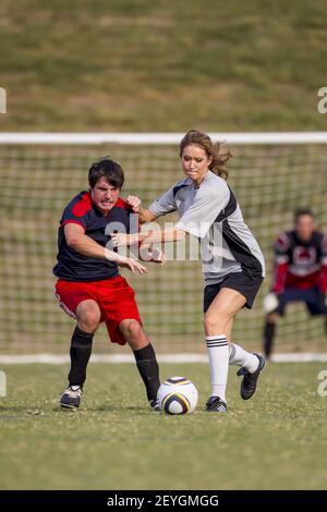 soccer players - female and male at soccer stadium. ready for game in ...