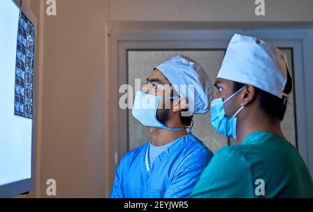 Pulmonologist and general surgeon watching x-ray scan before surgery ...