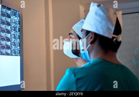 Pulmonologist and general surgeon watching x-ray scan before surgery ...