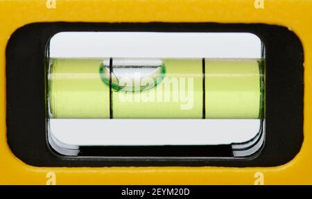 Spirit level bubble close up showing perfectly level alignment. Workman ...