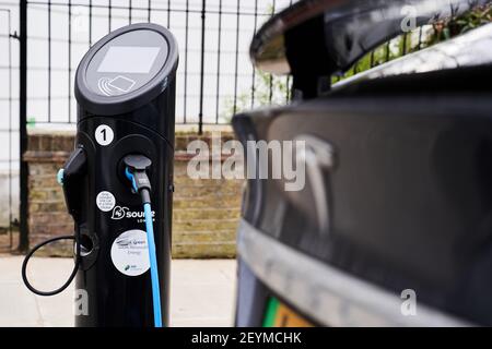 A Tesla car using a Source London EV charging point, London. Picture ...