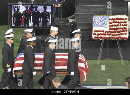 Members of the military carry the casket of Chris Kyle at Cowboys ...