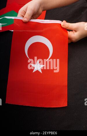 Child hand holding Turkish flag with white star and moon Stock Photo ...