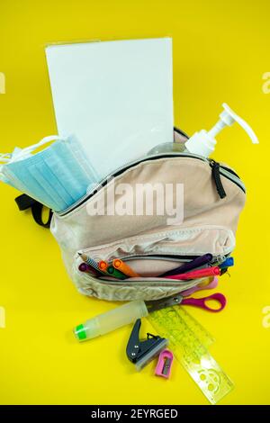 Student school bag pack with sanitizer, a face mask, pencils, books and ...
