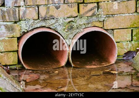 Sewers with toxic dirty water from metal pipes. Draining water from ...