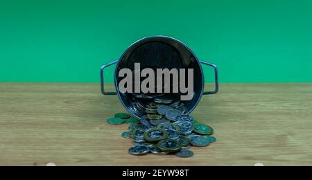 Singapore Dollar silver coins spilling from silver pail. Isolated Stock ...