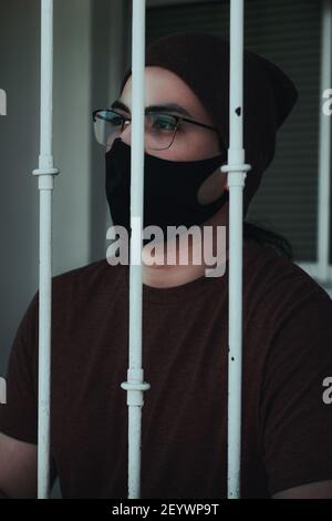 Portrait young male prisoner in uniform sitting prison cell Stock Photo ...
