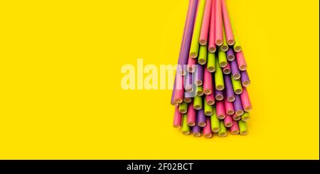 A closeup of paper straws on a yellow background Stock Photo - Alamy