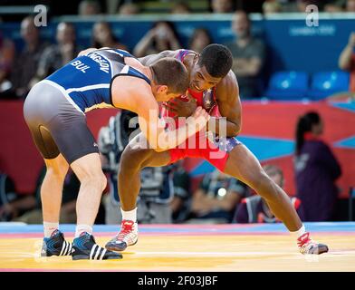 USA's Ellis Coleman (red) wrestles Bulgaria's Ivo Angelov (blue) during ...