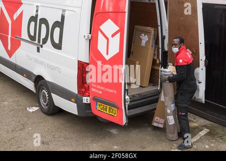 dpd driver picks up parcel from van for drop-off to customer Stock ...