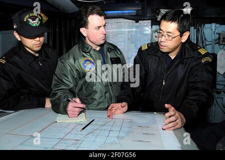 US Navy Commander, Destroyer Squadron Two Three, gives his son a teddy ...