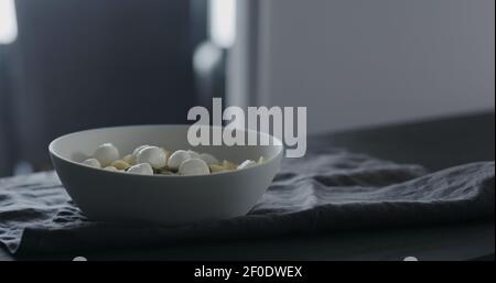 put mozzarella on fettuccine in white bowl on linen cloth, wide photo ...