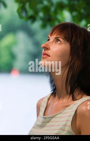 Portrait of nice satisfied calm young person wear white blue striped t ...