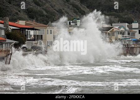 Waves crash on homes in New Haven CT USA as a storm off the coast with ...
