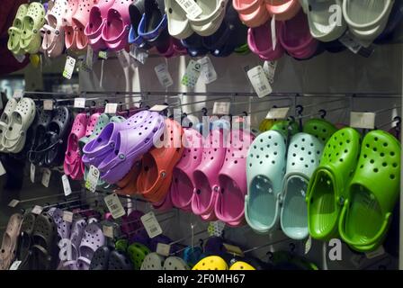 Crocs Shoes hanging on a display rack Stock Photo - Alamy
