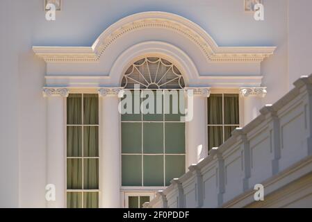 Stone swag and carvings are seen above the windows and columns of the ...