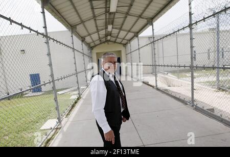 Val Verde County sheriff D'Wayne Jernigan (right) stands near a control ...