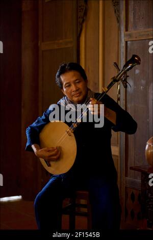 Musician playing Dan Nguyet or Moon Lute Tam Coc Ninh Binh Province ...