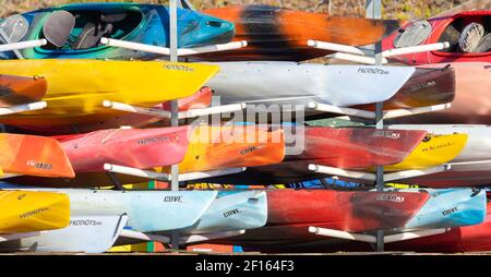 A red and yellow rental kayaks stacked on top of each other Stock Photo ...
