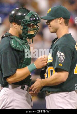 Oakland Athletics starting pitcher Adam Oller winds up to deliver the ...