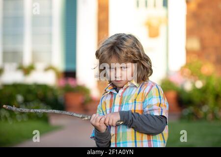 Child negative aggression. Kids emotion concept. Angry boy with stick ...