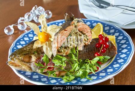 Fried stuffed fish on a platter festive menu Stock Photo - Alamy