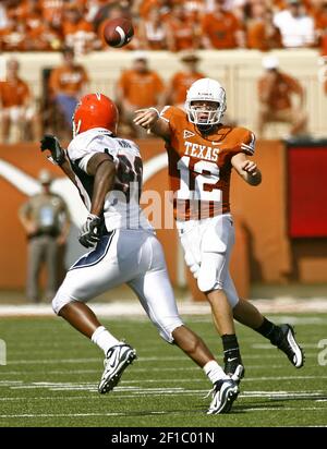 Texas quarterback Colt McCoy (12) is tackled by Texas A&M's Kyle Mangan ...