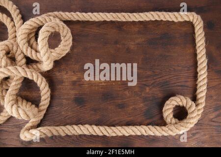Strong Rope Frame on wooden Background Stock Photo - Alamy