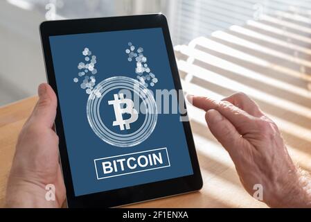 Tablet screen displaying a bitcoin concept Stock Photo - Alamy