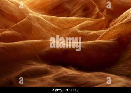 A wrinkled and grooved orange cloth texture background Stock Photo - Alamy
