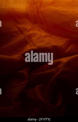 A wrinkled and grooved orange cloth texture background Stock Photo - Alamy