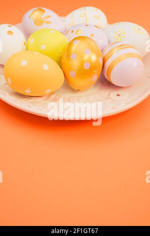 A vertical shot of a plate with decorated Easter eggs isolated on ...