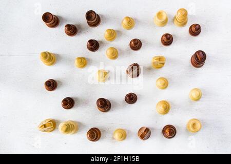 A top view of small wooden chess figures of both sides horizontally put ...