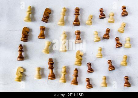A top view of small wooden chess figures of both sides horizontally put ...