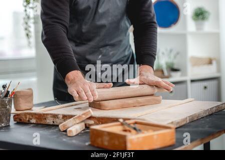 Man forming mold from pottery clay Stock Photo - Alamy