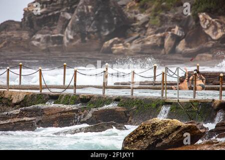 Avalon Beach Rockpool with wild ocean surf and people swimming in the ...