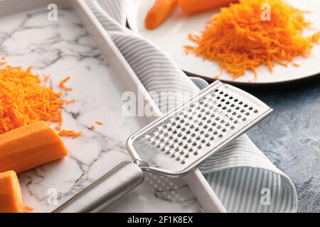 metal grater and fresh carrots closeup on cutting board Stock Photo - Alamy