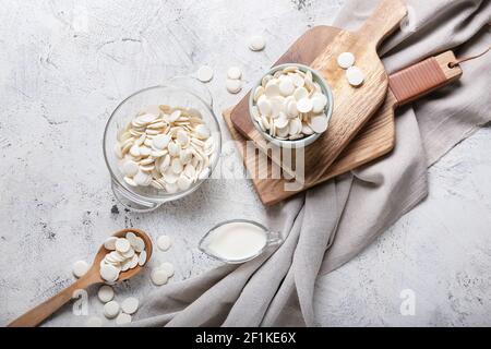 Bowls with chocolate drops on light background Stock Photo - Alamy