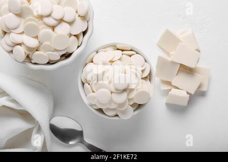 Bowls with chocolate drops on light background Stock Photo - Alamy