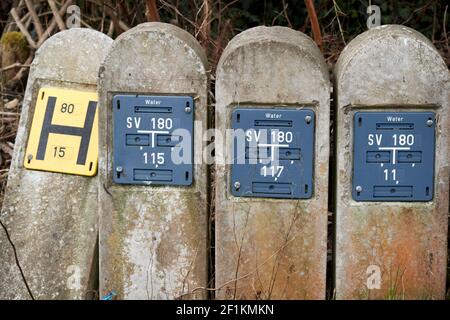 Concrete water main marker post showing pipe diameter size and distance ...