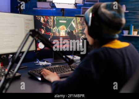 Pro gamer streaming video games with green screen mock-up display in ...