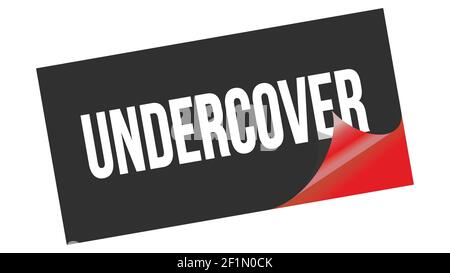 UNDERCOVER text written on red grungy zig zag borders round stamp Stock ...