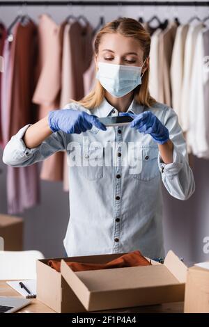 Seller in medical mask taking business card from african american ...