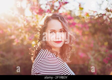 Middle age woman wearing striped t-shirt standing over isolated pink ...