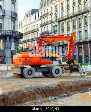Excavators dig at a construction site of a street and a subway. Baggers ...