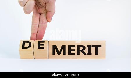Demerit or merit symbol. Businessman turns wooden cubes and changes the ...