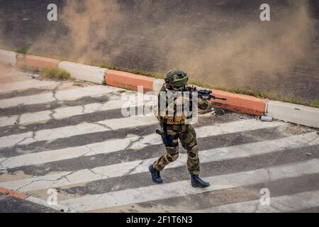 Soldier running with assault rifle in hand, studio shot isolated on ...