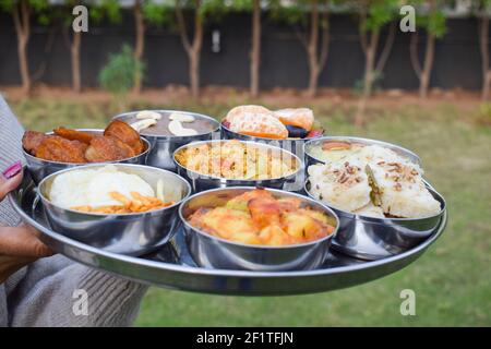 Traditional Farali indian food served in thali and bowls with many ...