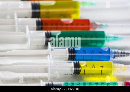 A closeup of different colorful chemicals in syringe needles on the ...